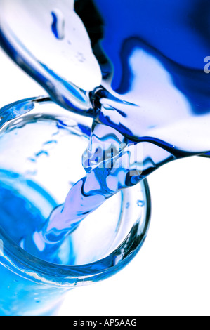 Pouring blue liquid from laboratory flask into petri dish. The concept ...