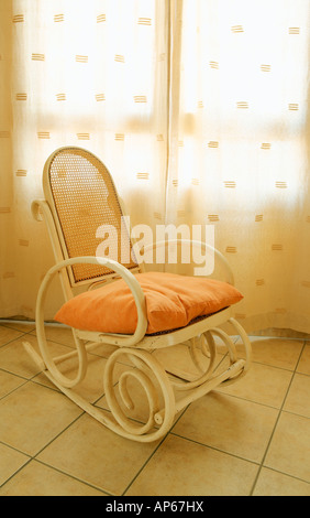 Wooden rocking chair near the window in room Stock Photo - Alamy