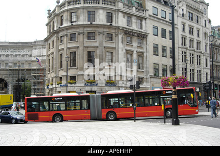 red arriva bendy bus travelling through the city of London England ...