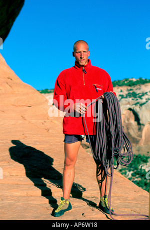 Portrait of young sportsman standing with USA flag on his shoulders and ...