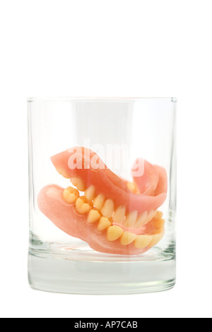 False Teeth in a glass high key white background Stock Photo - Alamy