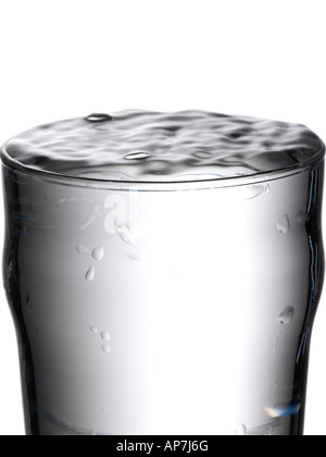 Overflowing glass of fresh water Stock Photo - Alamy