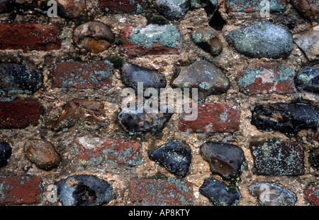 Detail of a flint and red brick wall, with circular patress wall tie ...