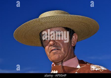 Huaso wearing traditional chupalla straw hat and poncho Chile Rapel ...
