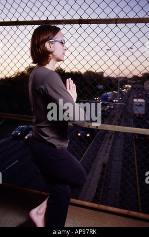 Woman doing yoga on a freeway overpass Stock Photo - Alamy