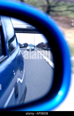 On the autobahn (highway) looking back through a cars mirror Stock ...