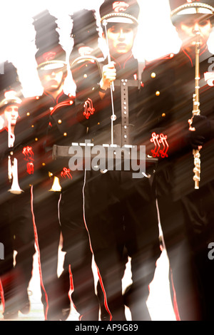 A group of students in school uniforms work together on a project in a ...