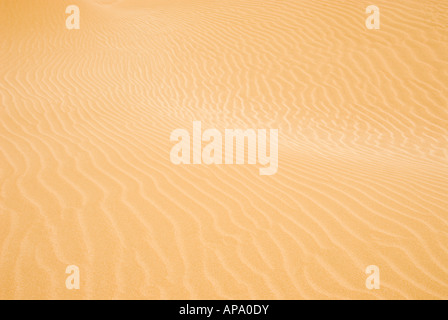 Patterns in yellow beach sand caused by water erosion Stock Photo - Alamy
