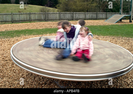 Group of children spinning on roundabout Stock Photo - Alamy