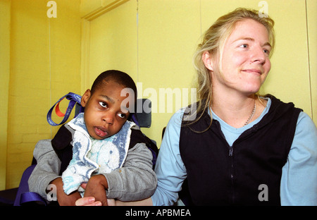 Autistic child with carer at a special school, Southwark, London, UK ...