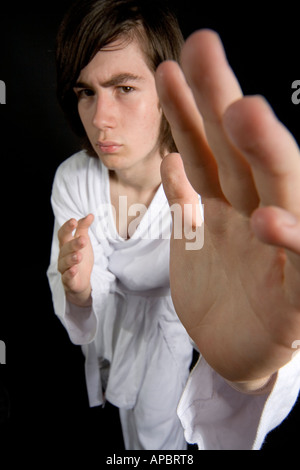 Young boy in karate outfit making fighting movement Stock Photo - Alamy