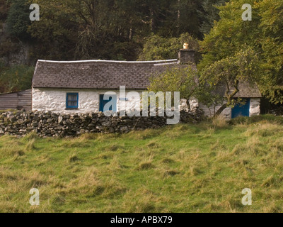 Isolated old Welsh stone cottage with slate roof and white washed walls ...