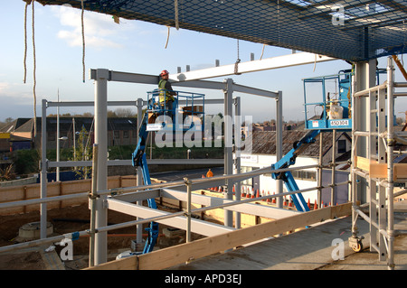 Construction workers lining up steel girder on steel fabricated ...