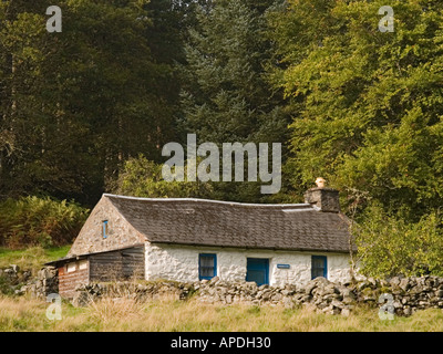 Isolated old Welsh stone cottage with slate roof and white washed walls ...
