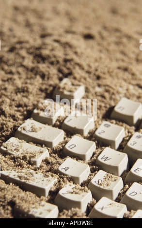 Keyboard covered in sand Stock Photo - Alamy