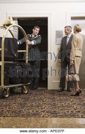 bellhop pushing luggage cart into elevator Stock Photo: 18084449 - Alamy
