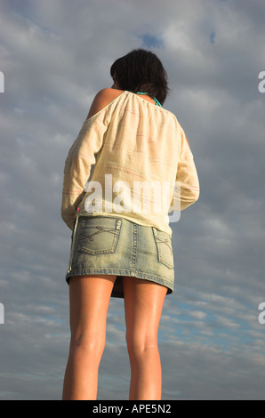 Rear view of woman standing against mountain Stock Photo - Alamy