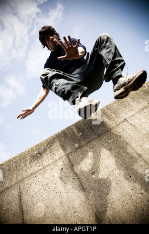 Man doing long jump Stock Photo - Alamy
