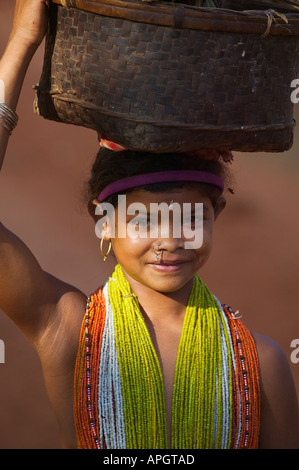 Portrait of a young Bondo girl wearing beads costume and carrying ...