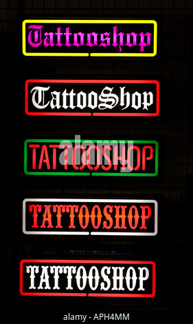 Lots of multi-coloured tattoo shop signs illuminate the streets ...