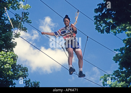 Teen aged girl on ropes challenge course Stock Photo - Alamy