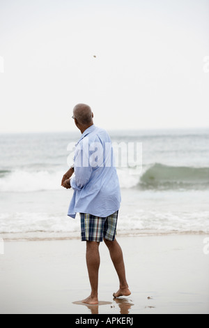 Man throwing stone water lake fun Stock Photo - Alamy