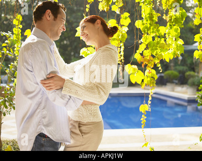 Couple hugging in swimming pool Stock Photo - Alamy