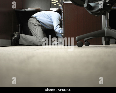 Office workers crawling under their desks Stock Photo - Alamy