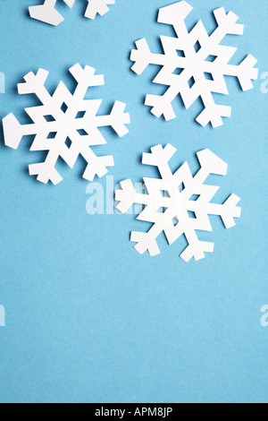 Paper snowflakes on blue background (close-up Stock Photo - Alamy