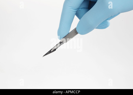 Hand holding scalpel Stock Photo - Alamy