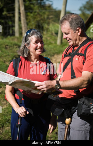 Walker reading map in countryside Stock Photo - Alamy