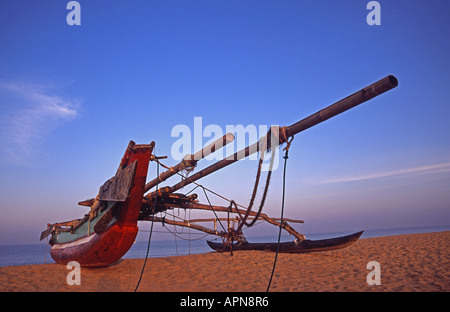 A traditional wooden oruwa fishing boat on shore in Bundala National ...