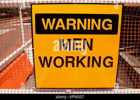 A yellow warning men working sign Stock Photo - Alamy