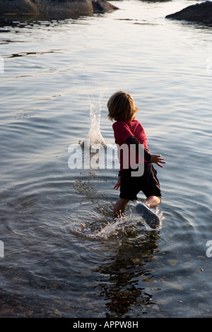 Boy (8-9) wading in water Stock Photo - Alamy