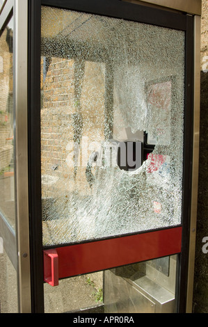 smashed up telephone box with broken glass Stock Photo - Alamy