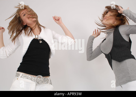 Two girls dancing shaking their heads around in a very energetic ...