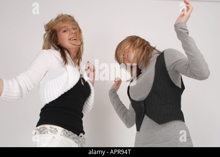 Two girls dancing shaking their heads around in a very energetic ...