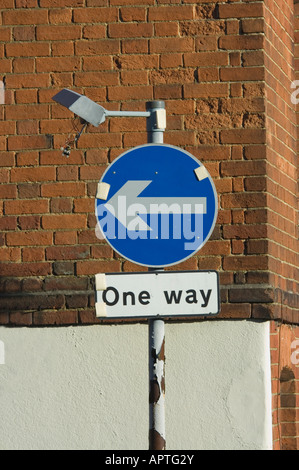 traffic sign pointing for one way travel Stock Photo - Alamy