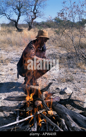 Bushman roasting Oryx meat in the fire Namibia Stock Photo: 15866774 ...