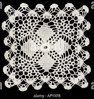 Handmade lace on black background. Macrame fabric lace doily. Crocheted ...