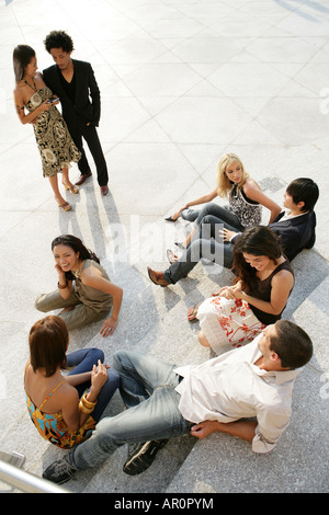 A Group Of Filipino Men Sit Outside A House Socialising During The ...