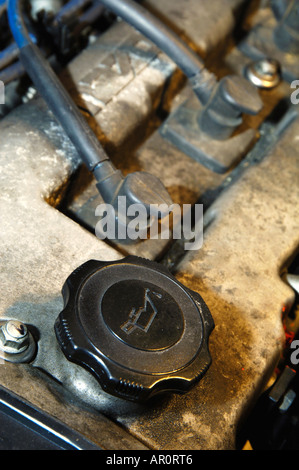 Filling a vehicle's engine with motor oil through a funnel Stock Photo ...