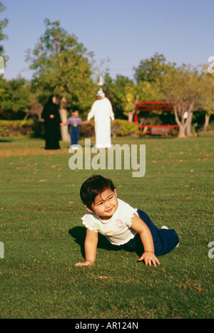 Infant crawling on the grass outdoors Stock Photo - Alamy