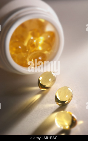 Vitamins tablets supplements Medicine coming out of bottle on Blue ...