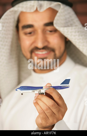 Arab Man with a toy airplane Stock Photo - Alamy