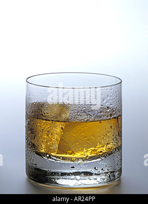 Whiskey in frosted glass with ice. Alcoholic drink with natural ice on ...
