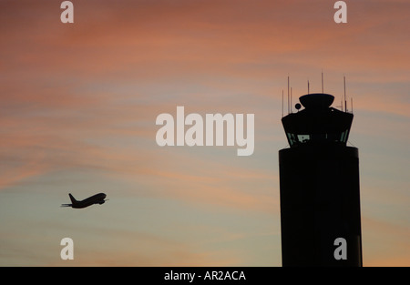 Airplane taking off past control tower Stock Photo - Alamy