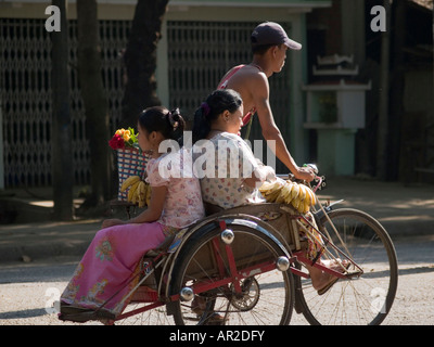 Passengers riding in a trishaw in (Rangoon) Yangon, (Burma) Myanmar ...