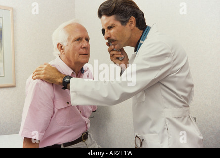 Doctor giving physical exam to seniors, Miami Stock Photo - Alamy