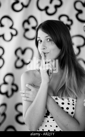 Close up of attractive woman shushing at camera, hiding secret, making ...